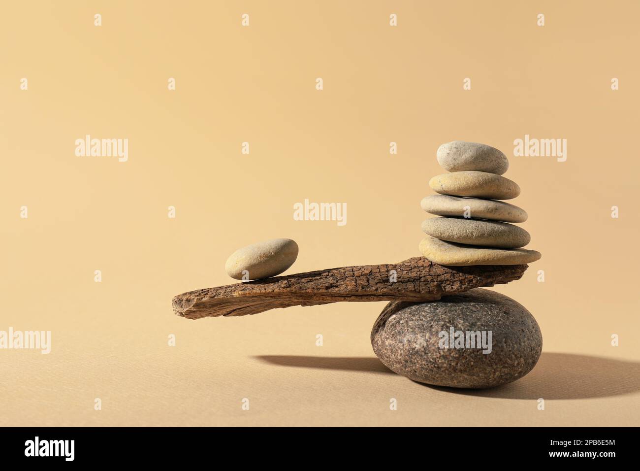 Stones with tree branch on beige background. Harmony and balance ...