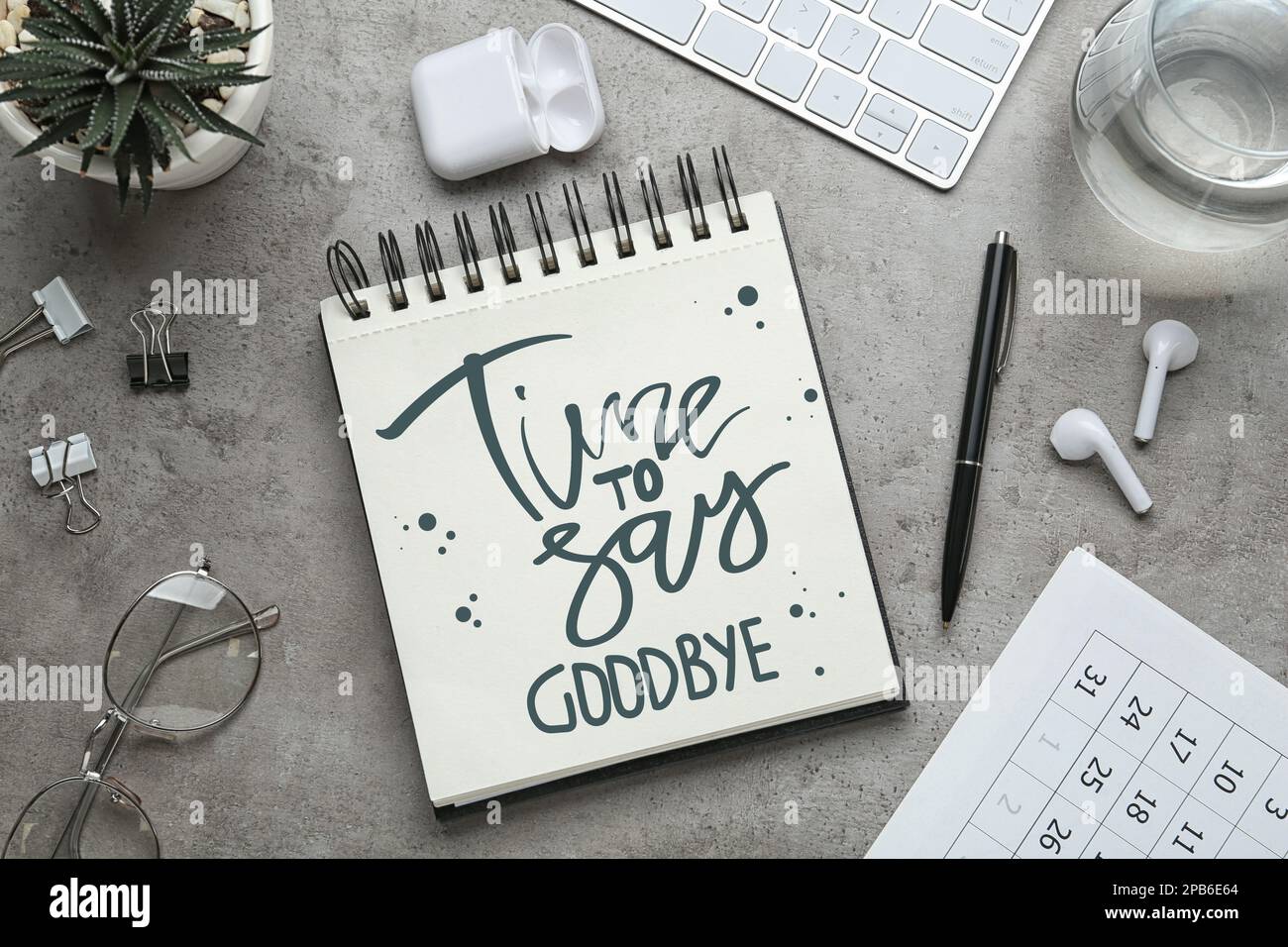 Time to say Goodbye. Flat lay composition with notebook on grey table ...