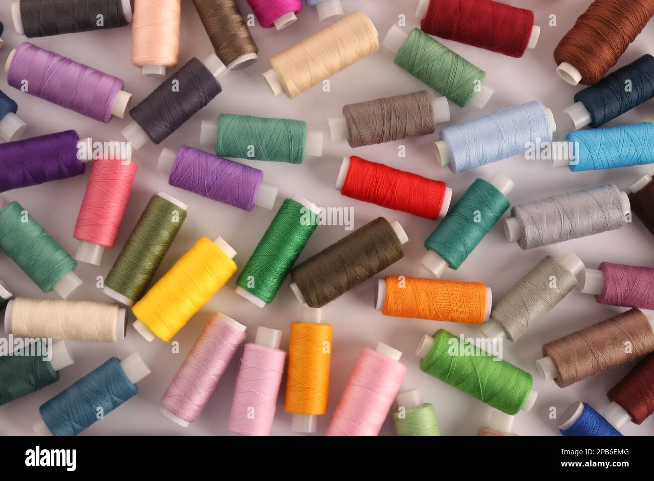 Set of colorful sewing threads on white background, flat lay Stock ...