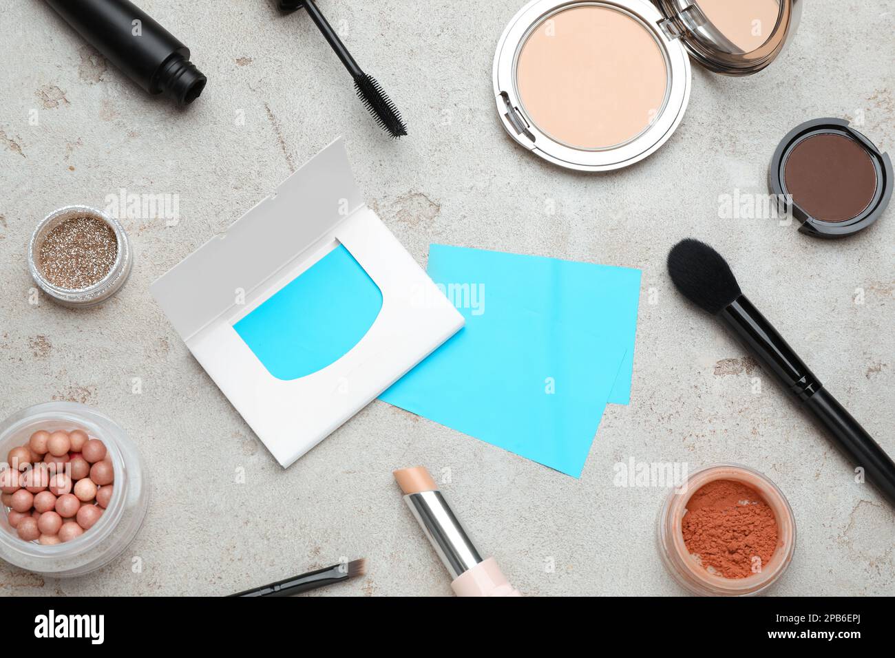 Facial oil blotting tissues and different decorative cosmetics on light ...