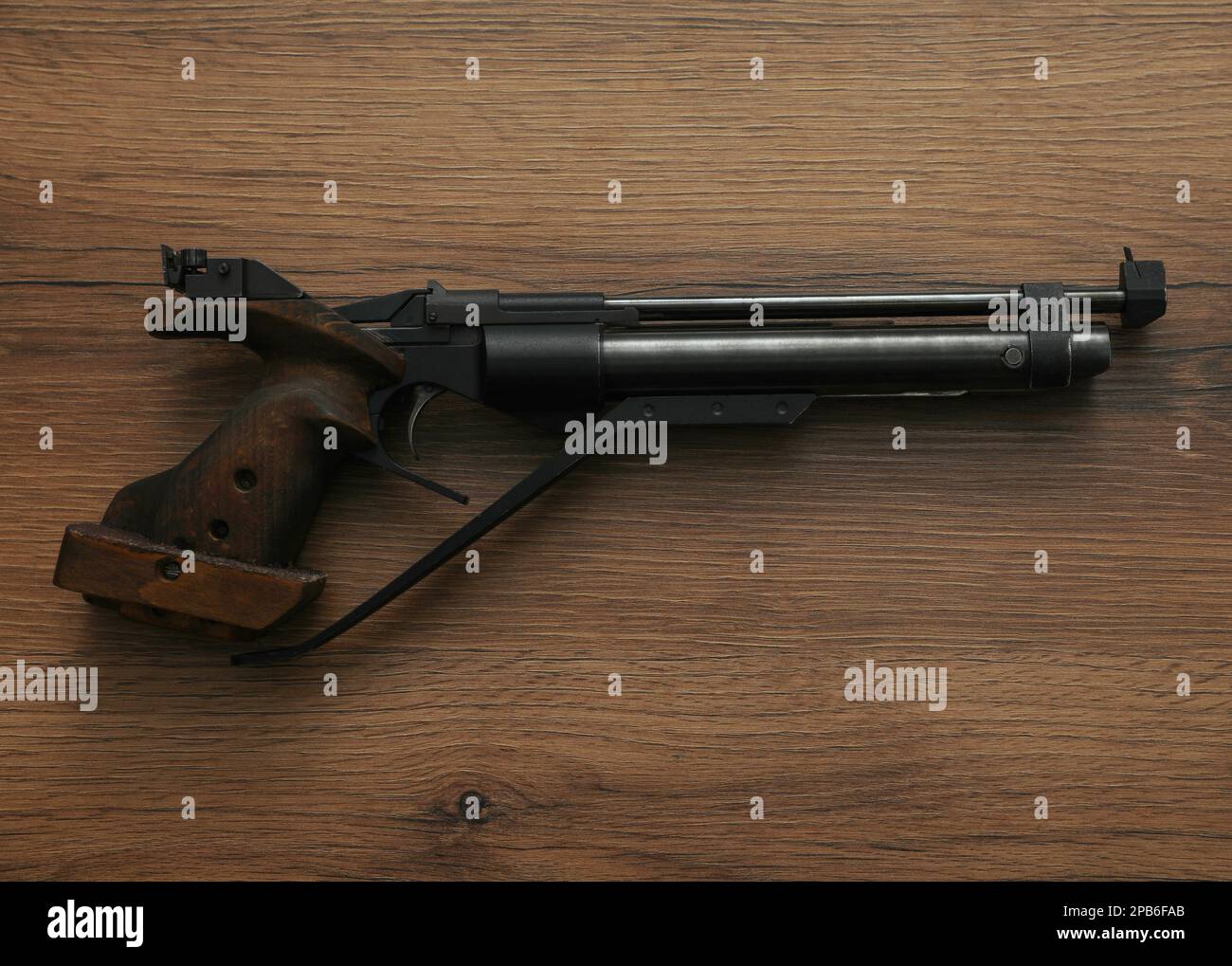 Gun shooting sport. Standard pistol on wooden table, top view Stock ...