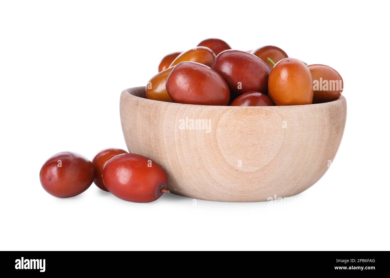 Ripe red dates in wooden bowl on white background Stock Photo - Alamy