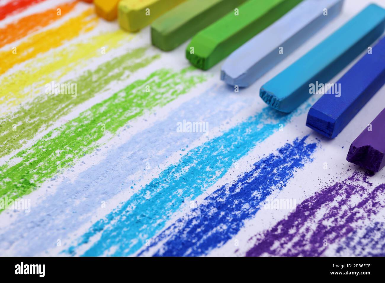 Colorful pastel chalks on white background, closeup. Drawing materials ...