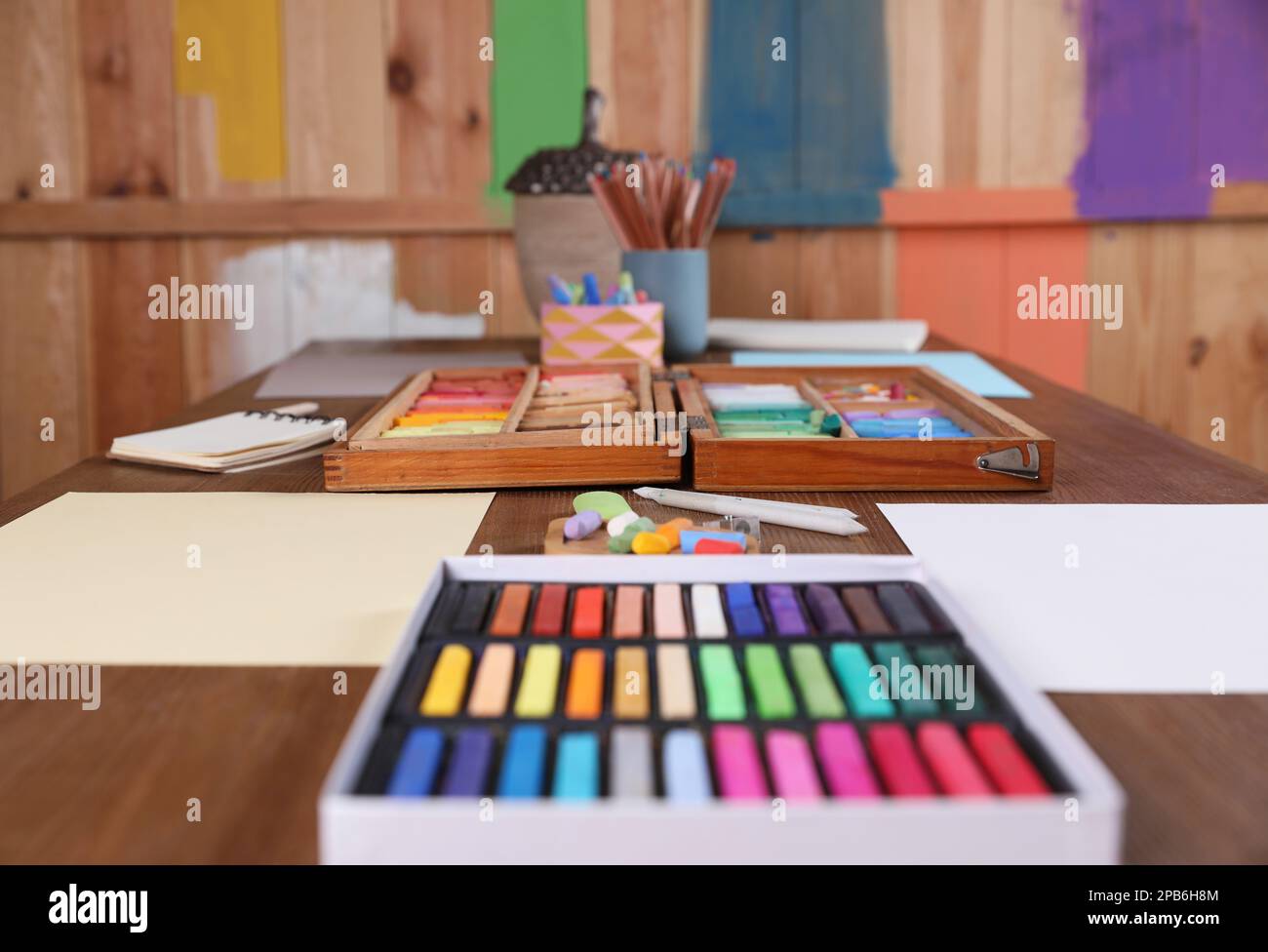 Blank sheets of paper, colorful chalk pastels and other drawing tools ...