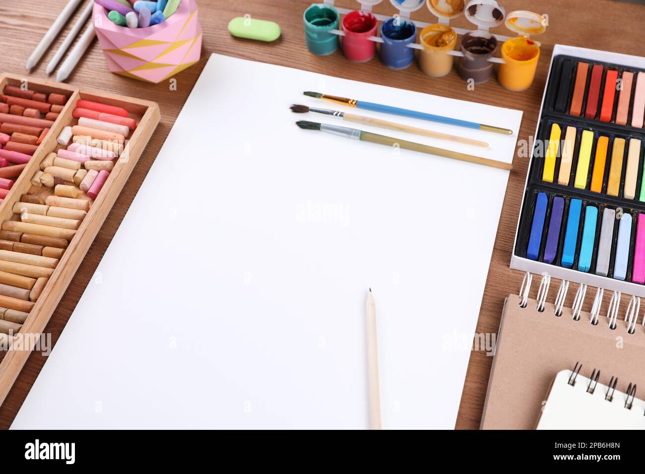 Blank sheet of paper, colorful chalk pastels and other drawing tools on ...