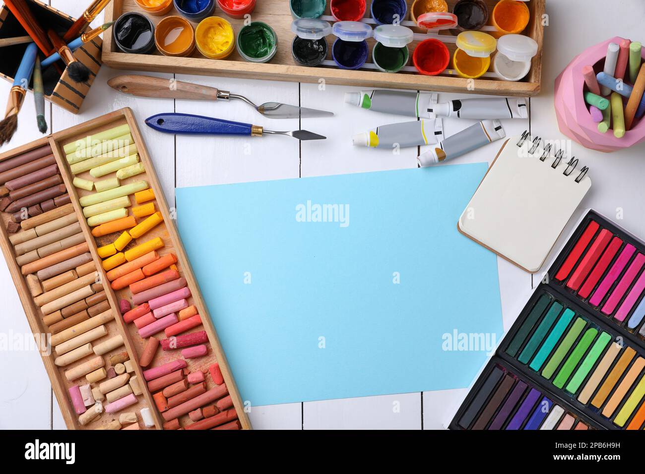 Blank sheet of paper, colorful chalk pastels and other drawing tools on ...