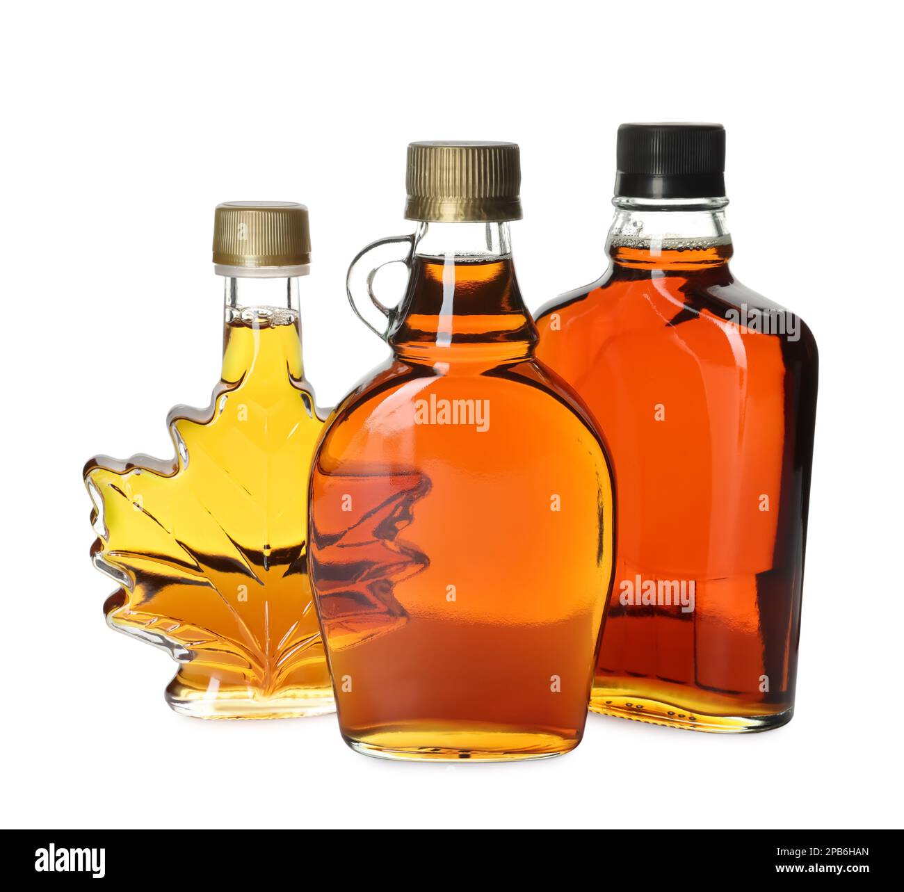 Different bottles of tasty maple syrup on white background Stock Photo ...