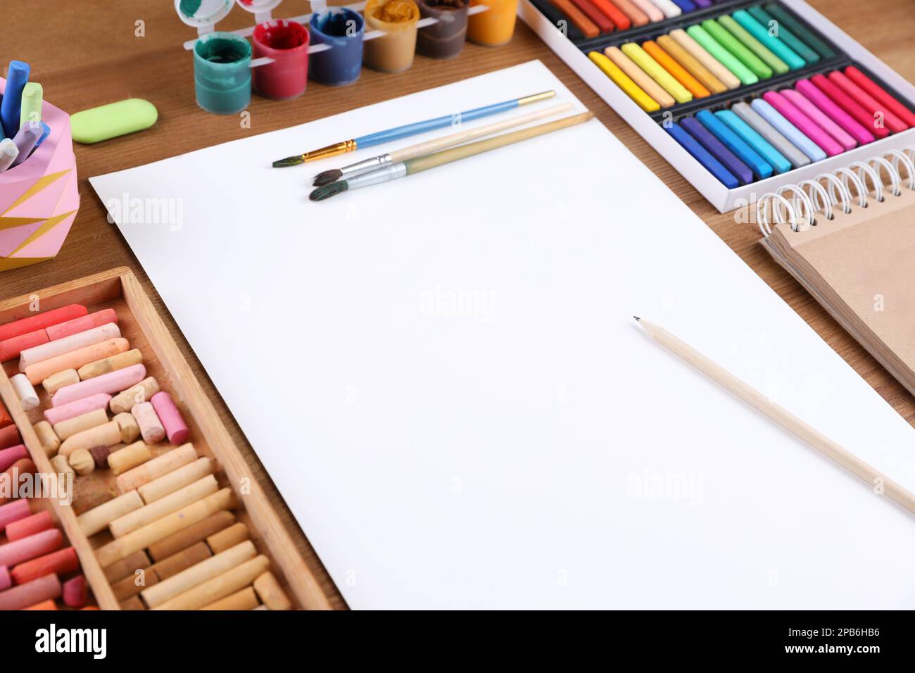 Blank sheet of paper, colorful chalk pastels and other drawing tools on ...
