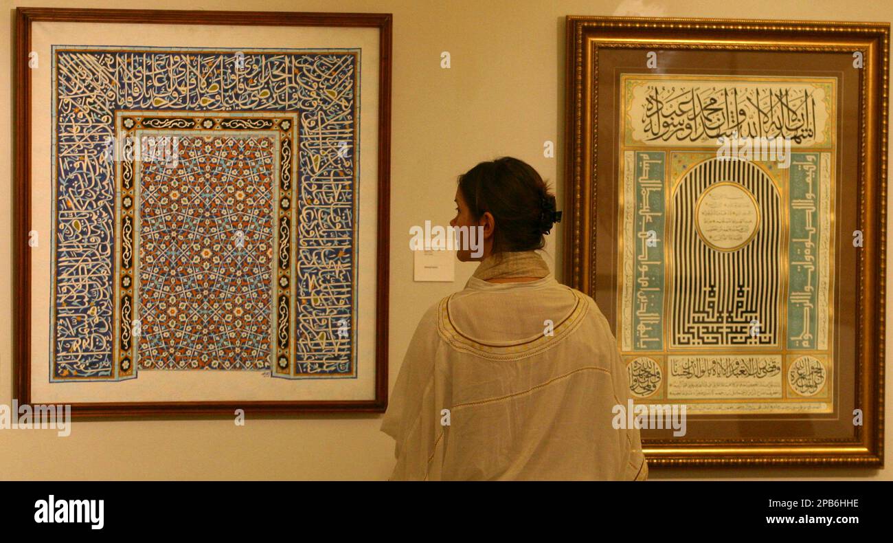 A visitor looks at Islamic calligraphy displayed at the newly opened ...