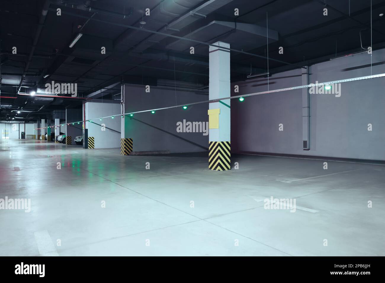 Modern parking garage with cars at night Stock Photo - Alamy