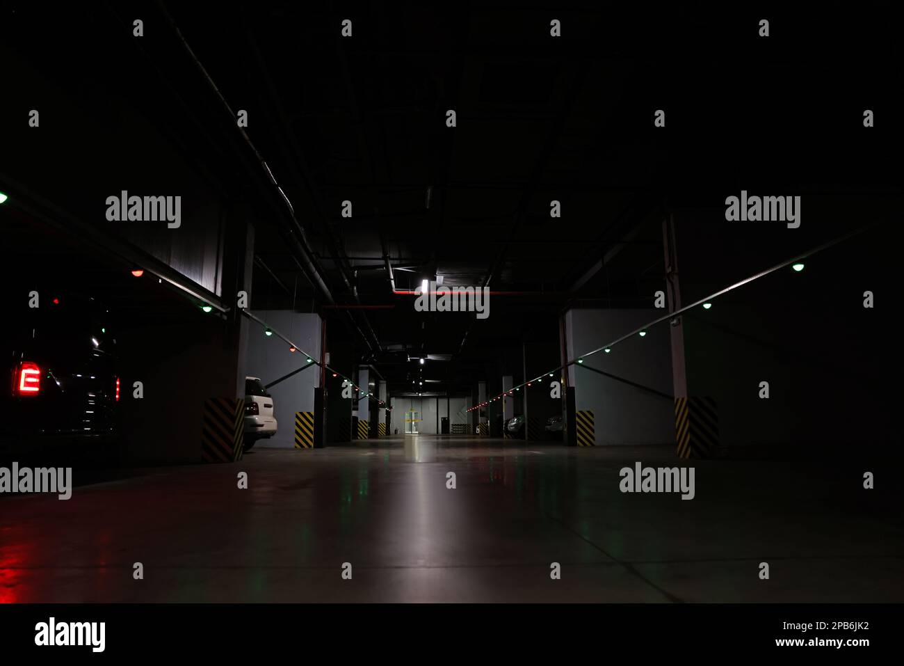 Modern parking garage with cars at night Stock Photo - Alamy