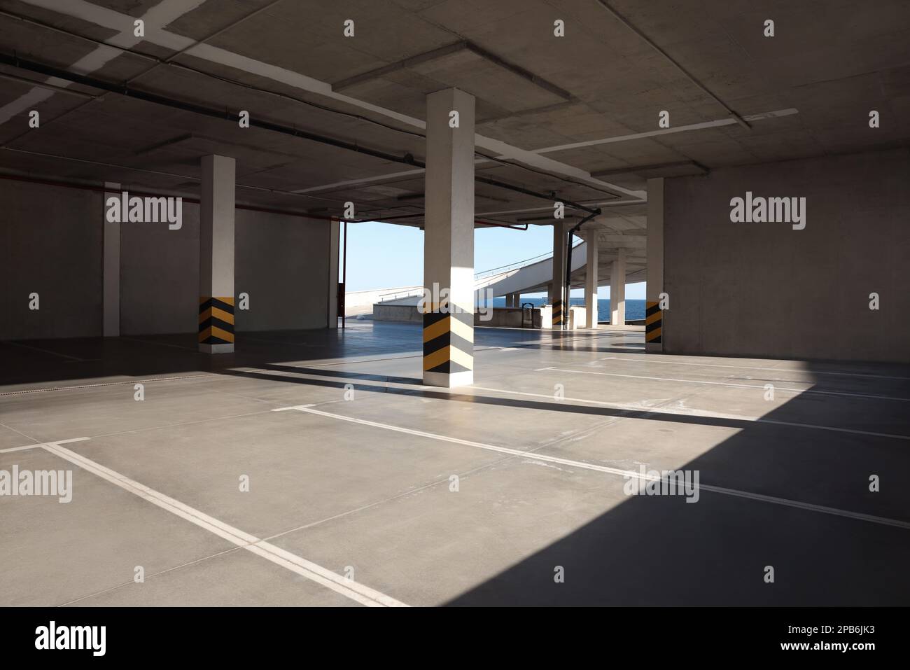 Empty open car parking near sea on sunny day Stock Photo - Alamy
