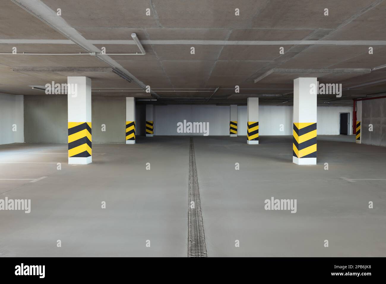 Empty car parking garage with warning stripes on columns Stock Photo ...