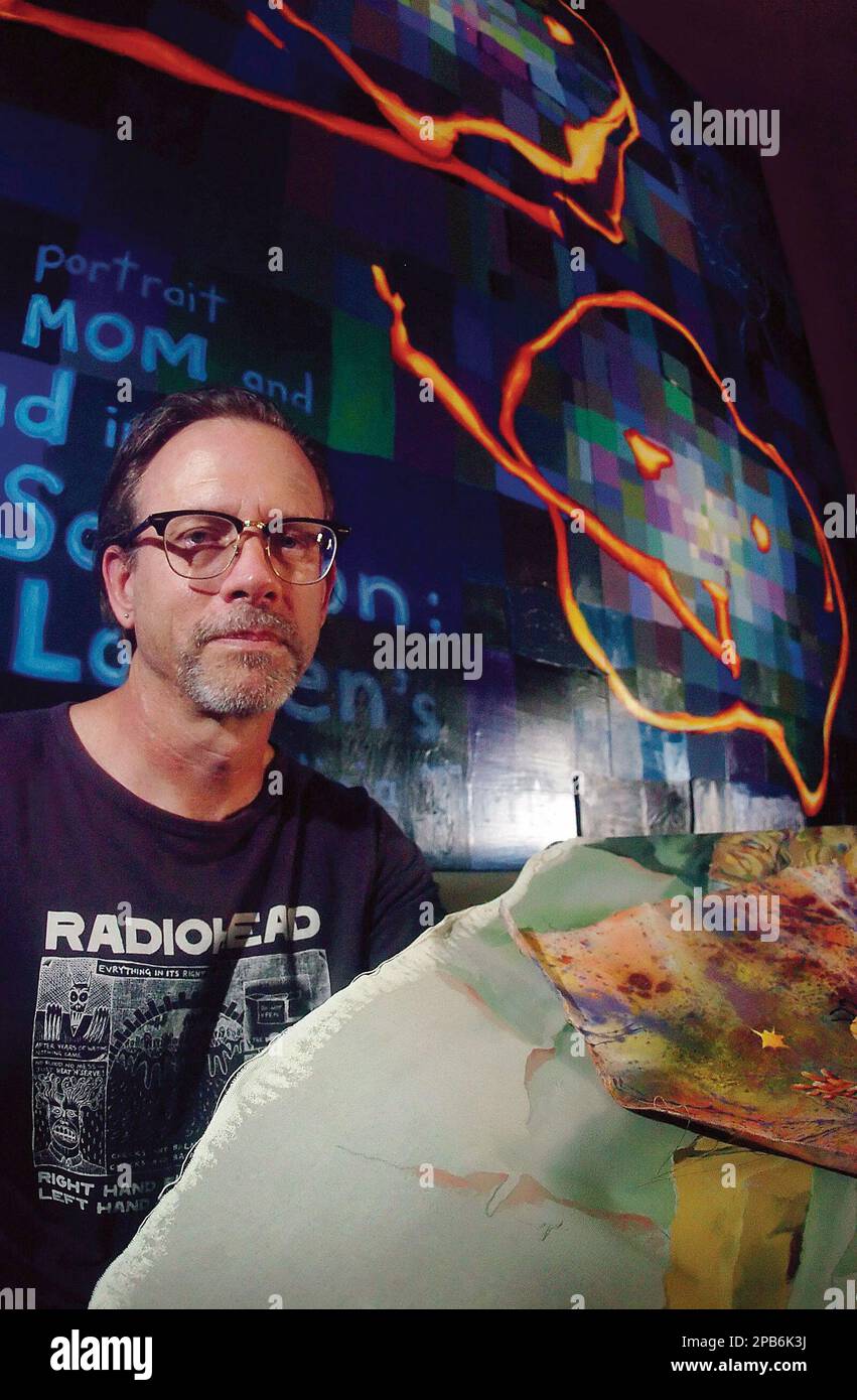 Artist Scott Jones poses with some of his art in his Yuma, Ariz. home ...