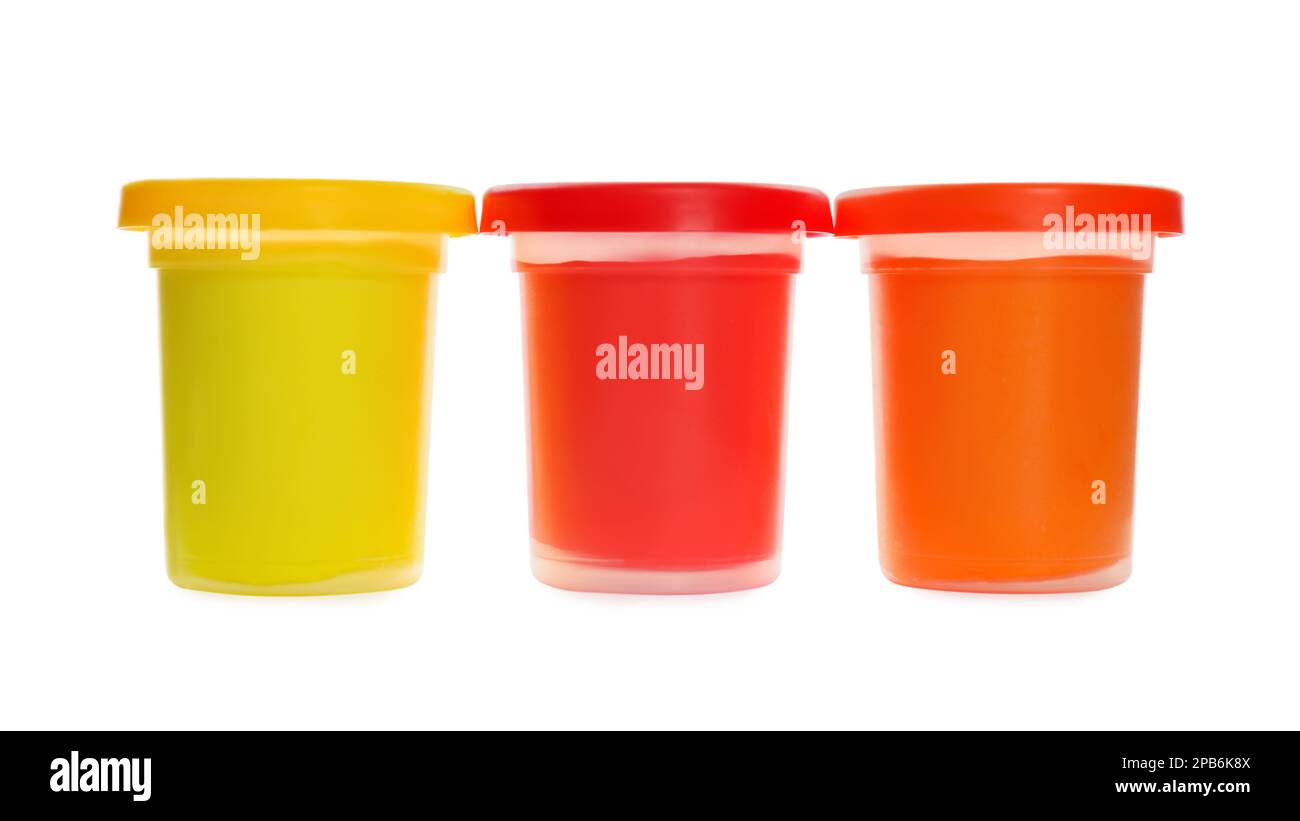 Plastic containers with different color play dough isolated on white ...