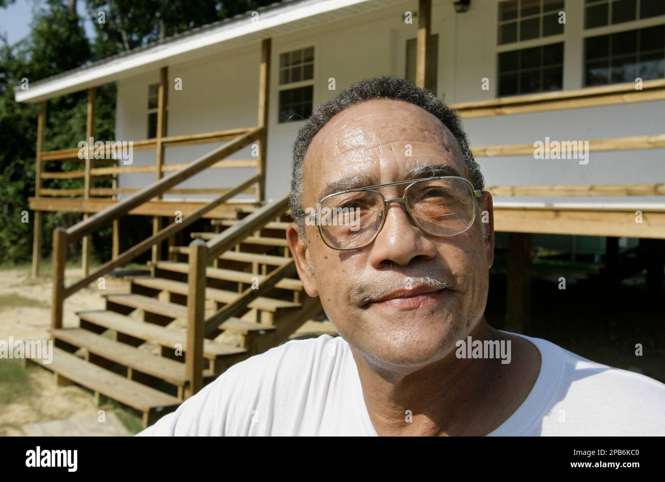 Adolph Harris poses for a photograph in front of his new home as he ...