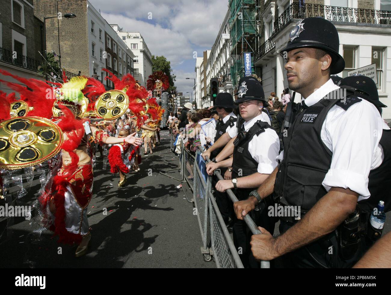 Under the watchful eye of British police officers, participants in ...