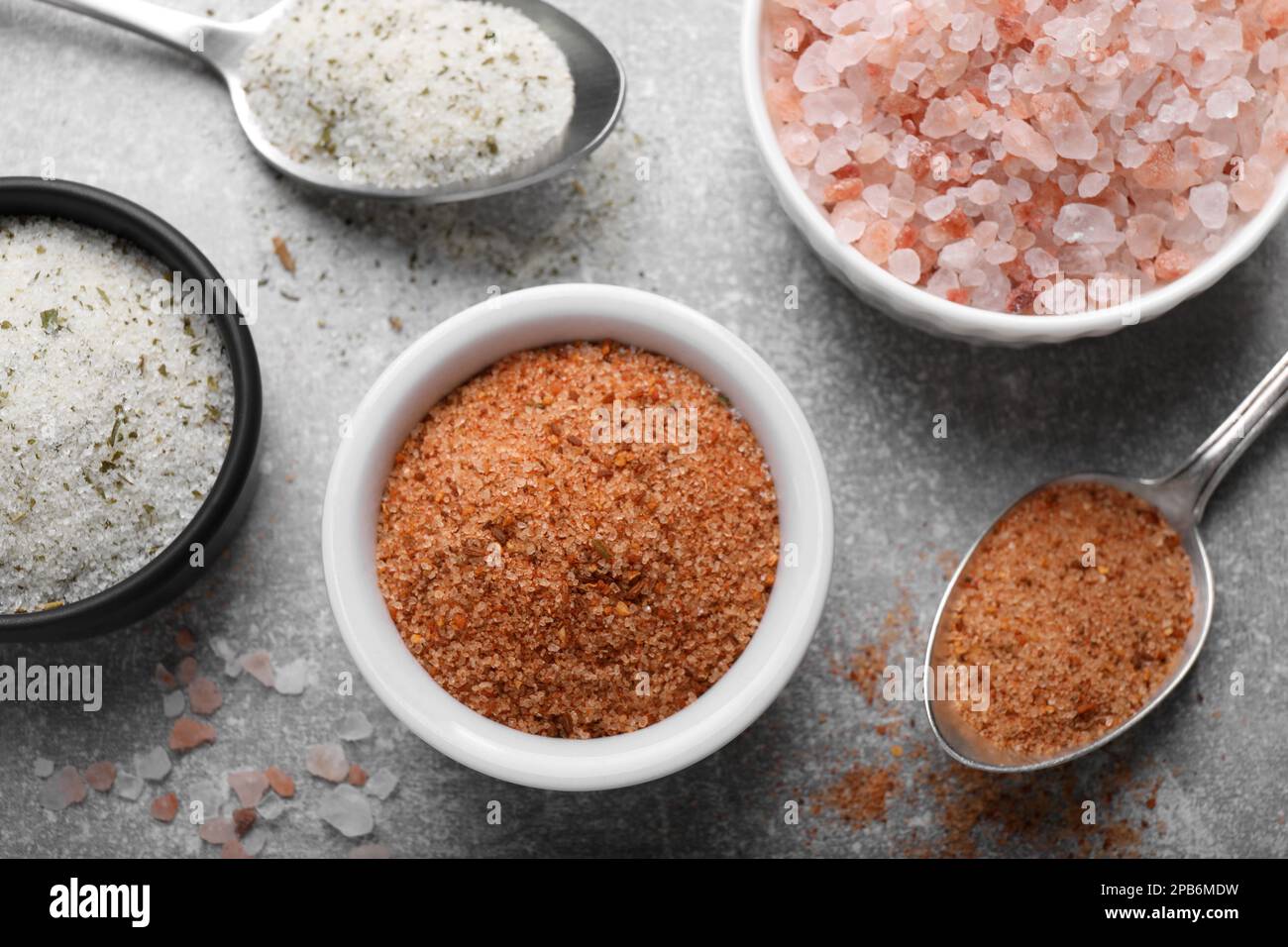 Different kinds of salt on grey table, flat lay Stock Photo - Alamy
