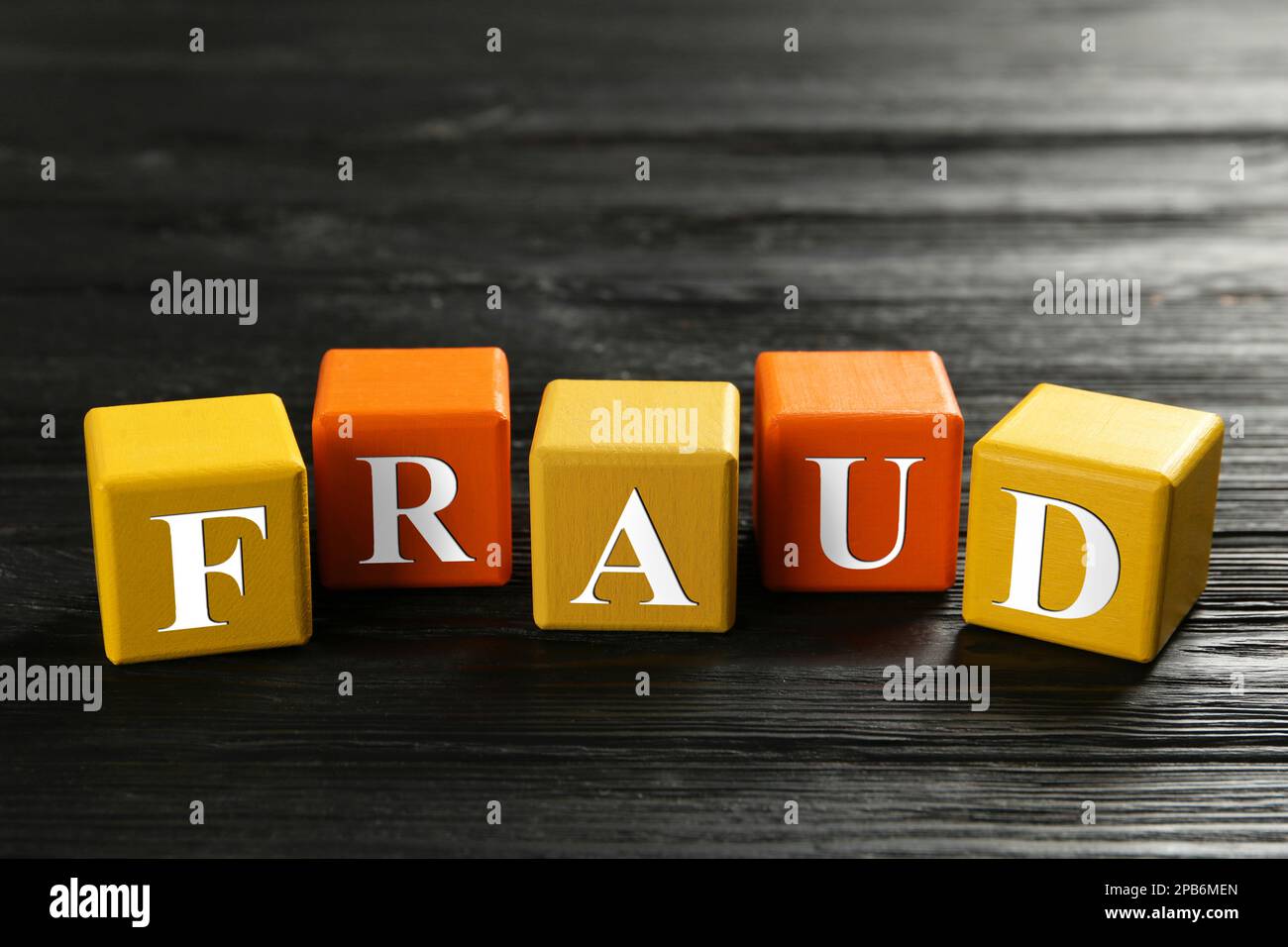 Cubes with word Fraud on black wooden background Stock Photo - Alamy