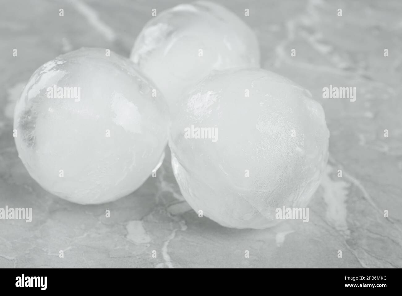 Frozen ice balls on grey marble table, closeup Stock Photo - Alamy