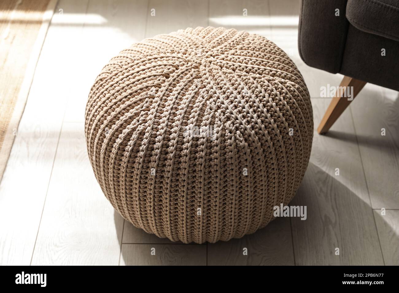 Stylish comfortable pouf in room. Home design Stock Photo - Alamy