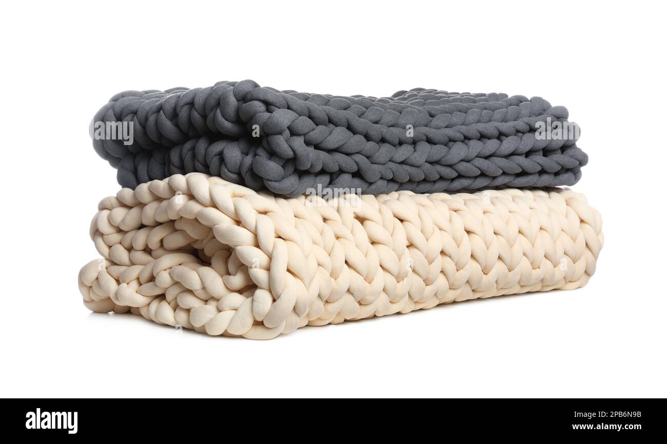 Chunky knit blankets folded on white background Stock Photo - Alamy