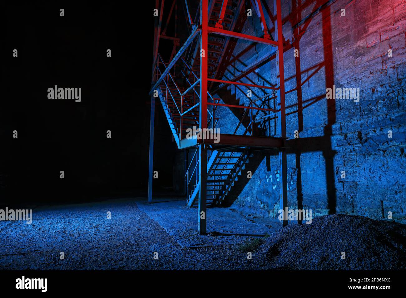 Old building with fire escape at night Stock Photo - Alamy