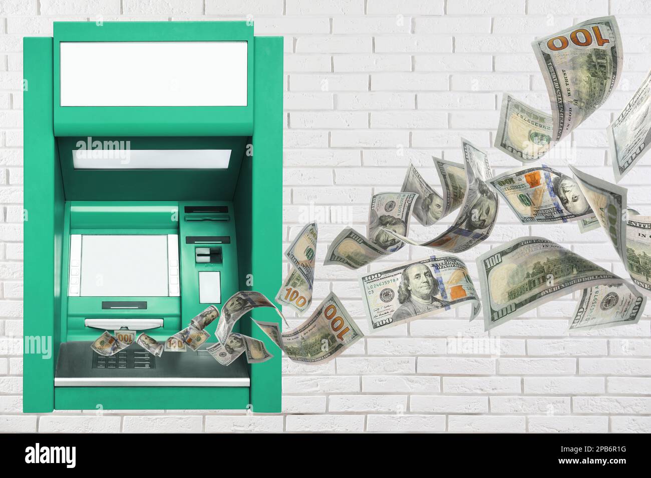 Modern automated cash machine on white brick wall and flying money Stock Photo - Alamy