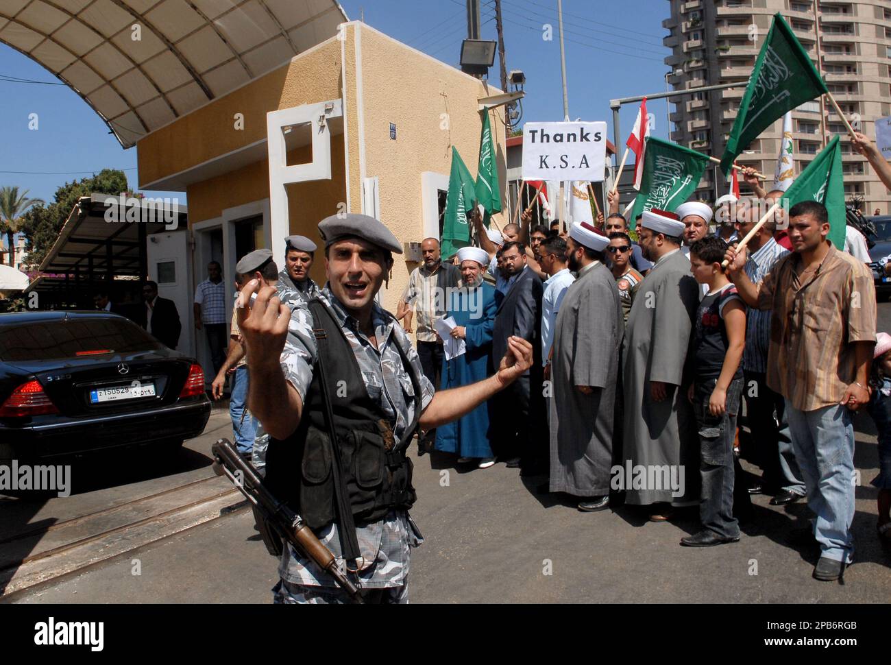 A Lebanese police gestures as he stands guard in front of the Saudi ...