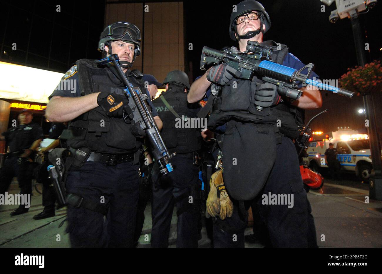 Heavily armed members of the Hercules Unit surround an entrance to ...
