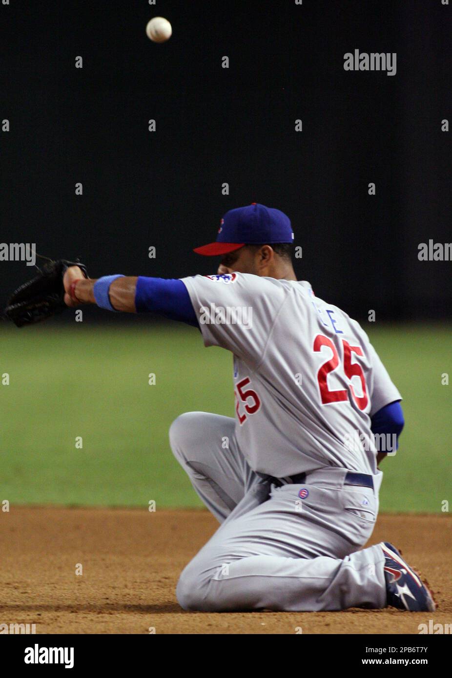 Chicago Cubs first baseman Derek Lee is unable to field a ground ball ...