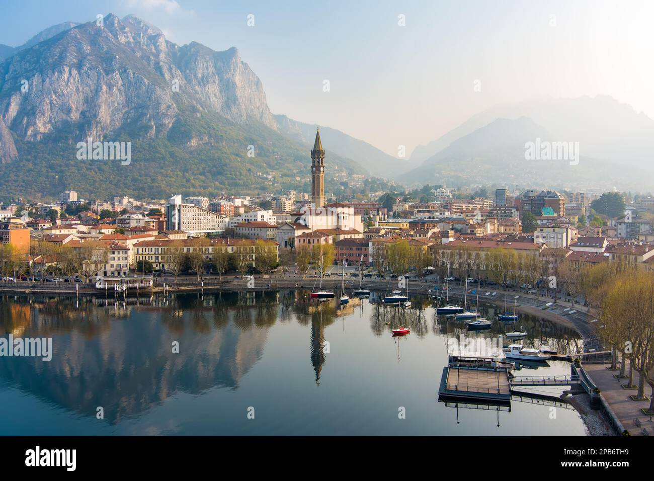 Foggy aerial sunrise cityscape of Lecco town on spring day. Picturesque ...