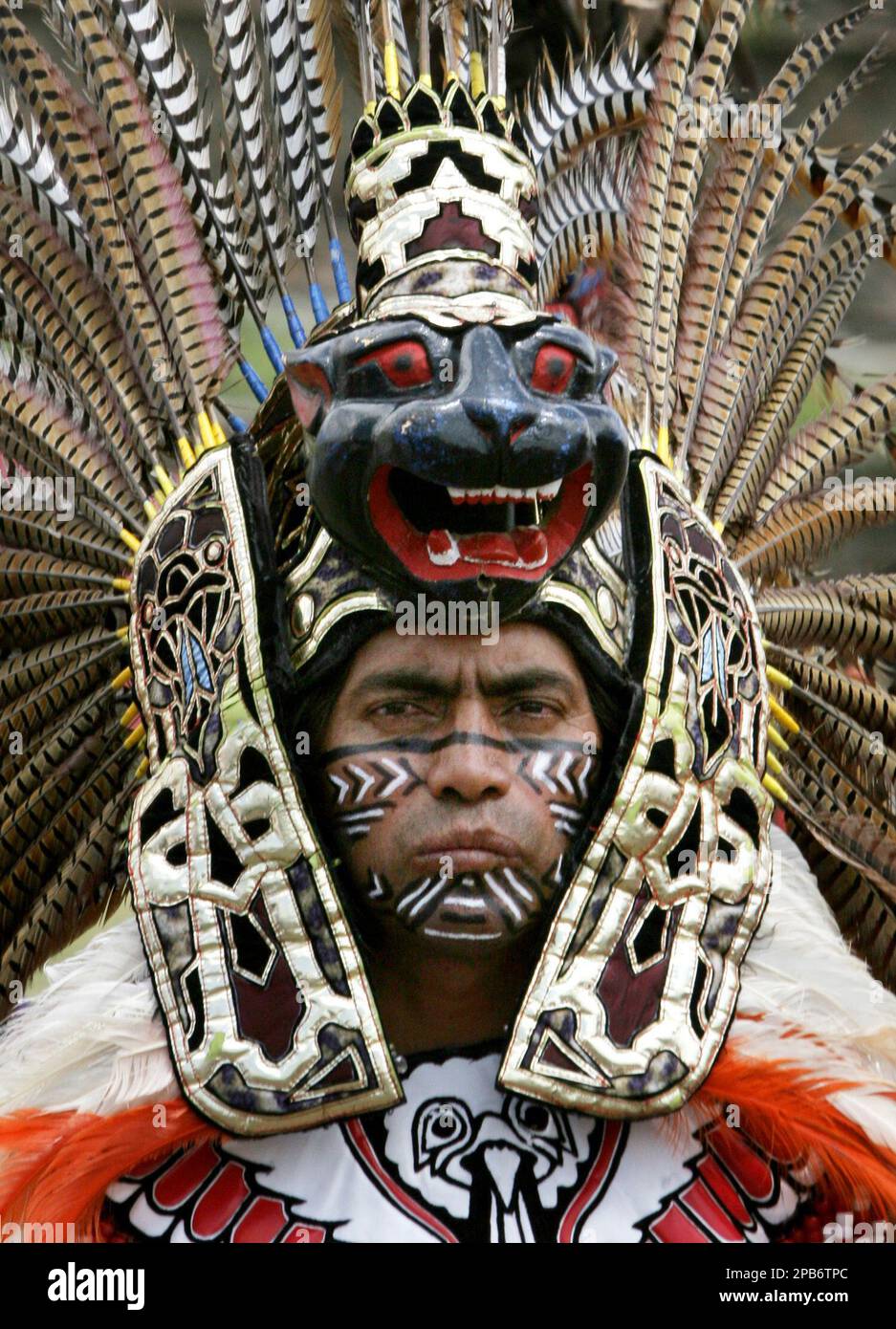A Mexican Azteca indigenous man dressed in traditional costume attends ...