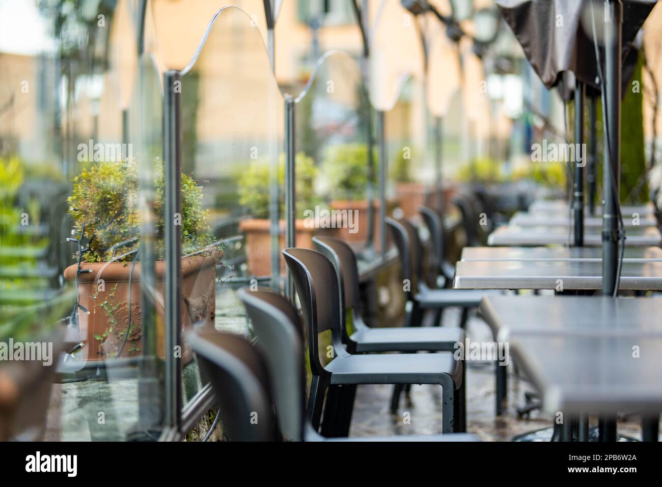 Empty outdoor restaurant tables wet after some rain in the city of ...