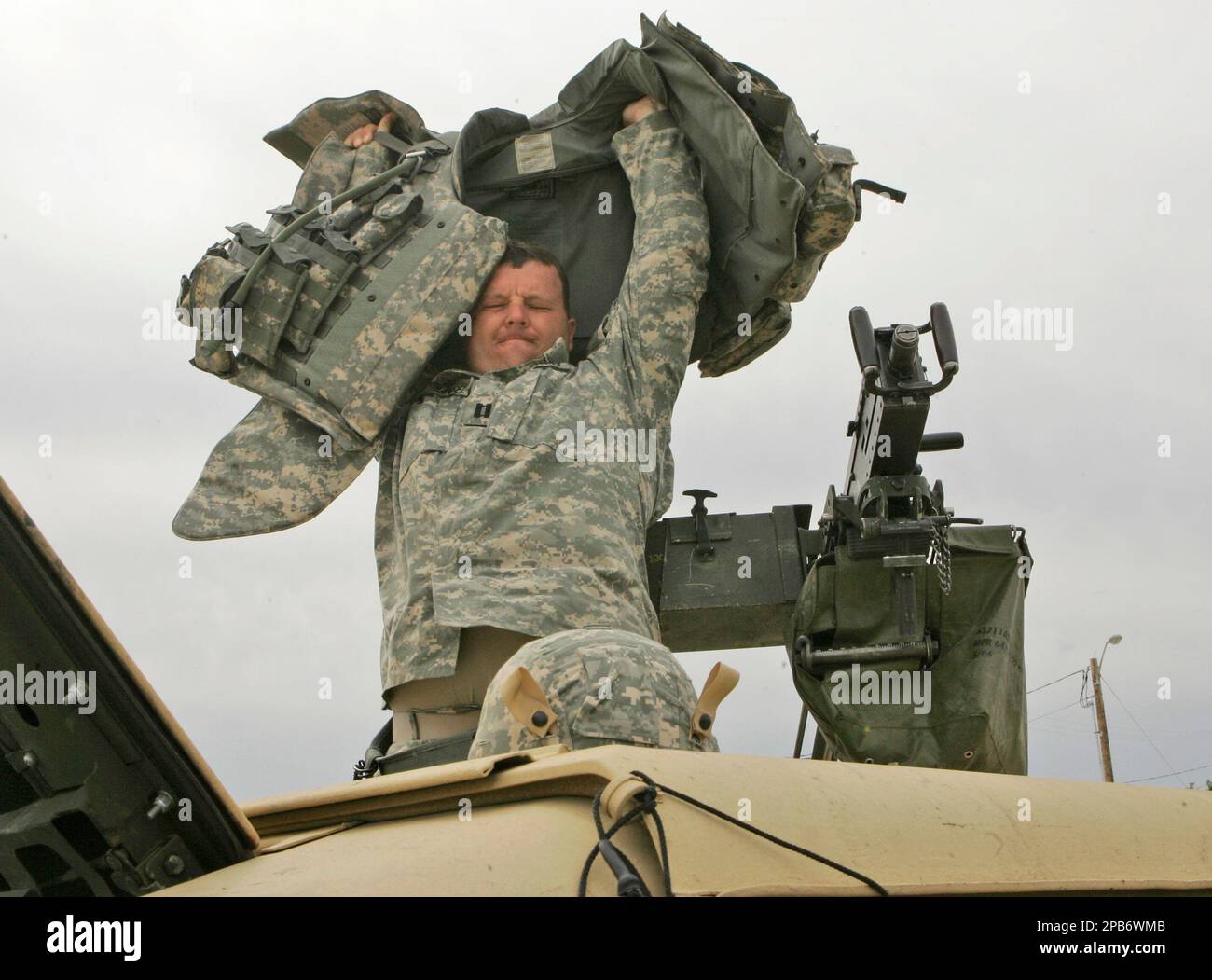 Capt. Gary Hansel dons his vest during transition training at Fort ...