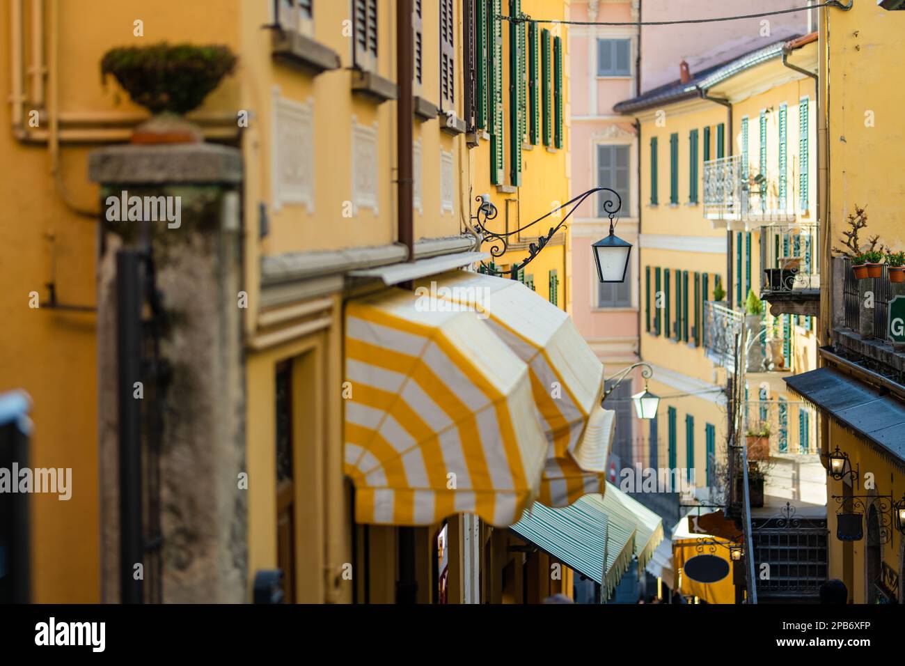 Narrow street full of shops and restaurants in Bellagio, one of the ...