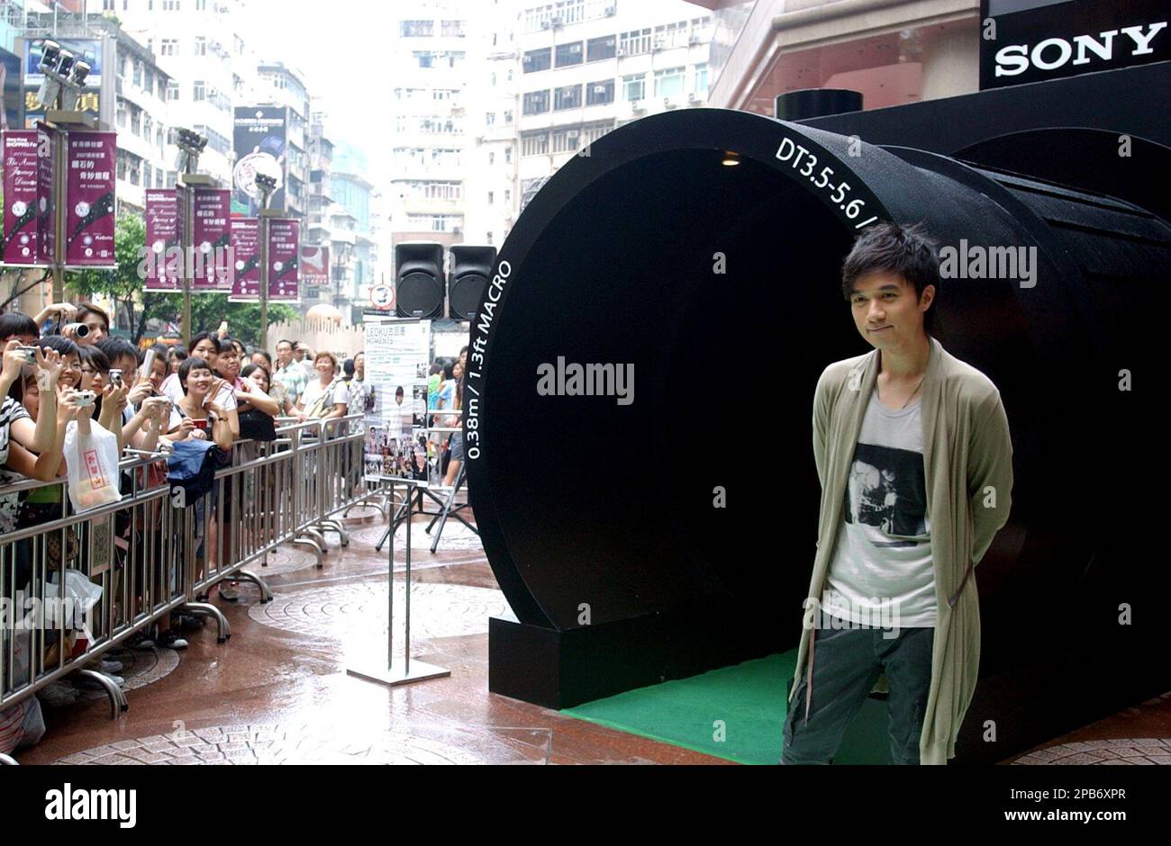 Hong Kong singer-actor Leo Koo poses beside a mock camera as he attends ...