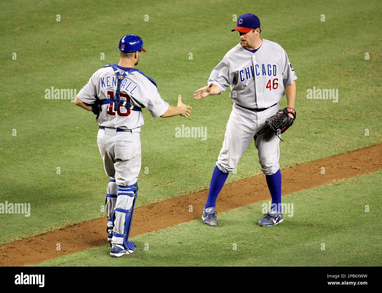Chicago Cubs pitcher Ryan Dempster (46) shakes catcher Jason Kendall's ...