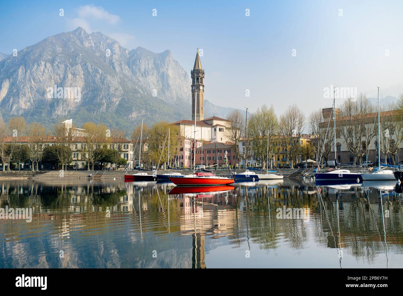 Colourful yachts docked at marina of Lecco town on spring day ...