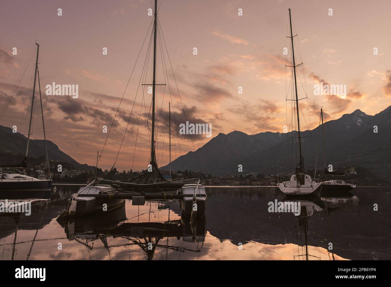 Colourful yachts docked at marina of Lecco town on spring sunset ...