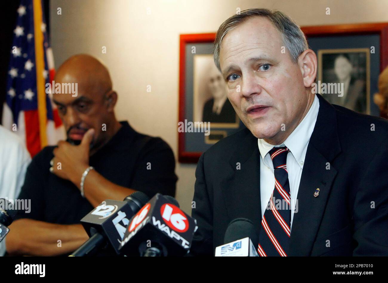 U.S. Attorney Dunn Lampton, foreground, credits Thomas Moore, in the ...
