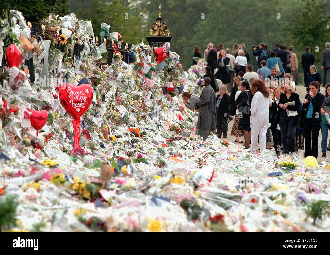 ** FILE ** Mourners file past the momentos left in memory of Princess ...