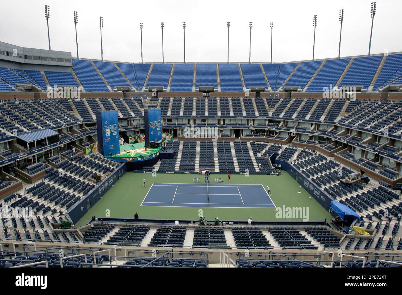 Tennis players practice in a nearly empty Arthur Ashe Stadium at the ...