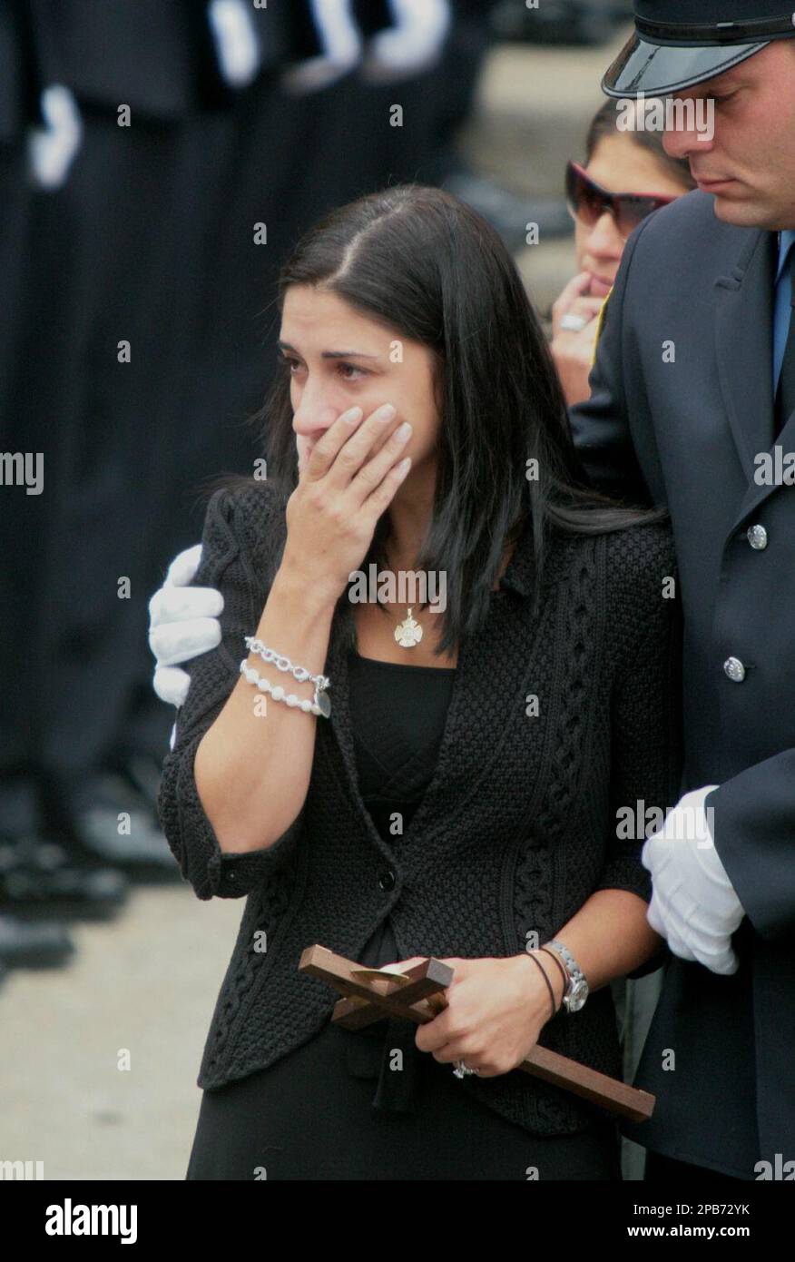 Linda Graffagnino is comforted as firefighters carry away the casket of ...