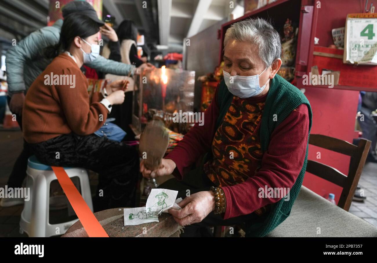 People perform a 'villain hitting' ceremony under the Canal Road ...