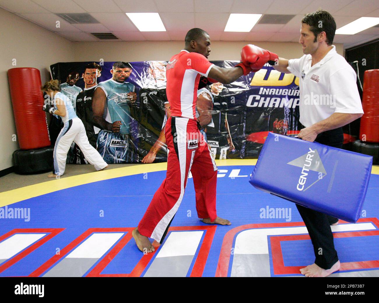 **ADVANCE FOR WEEKEND, AUG. 25-26**Anthony Njokuani, left, demonstrates ...
