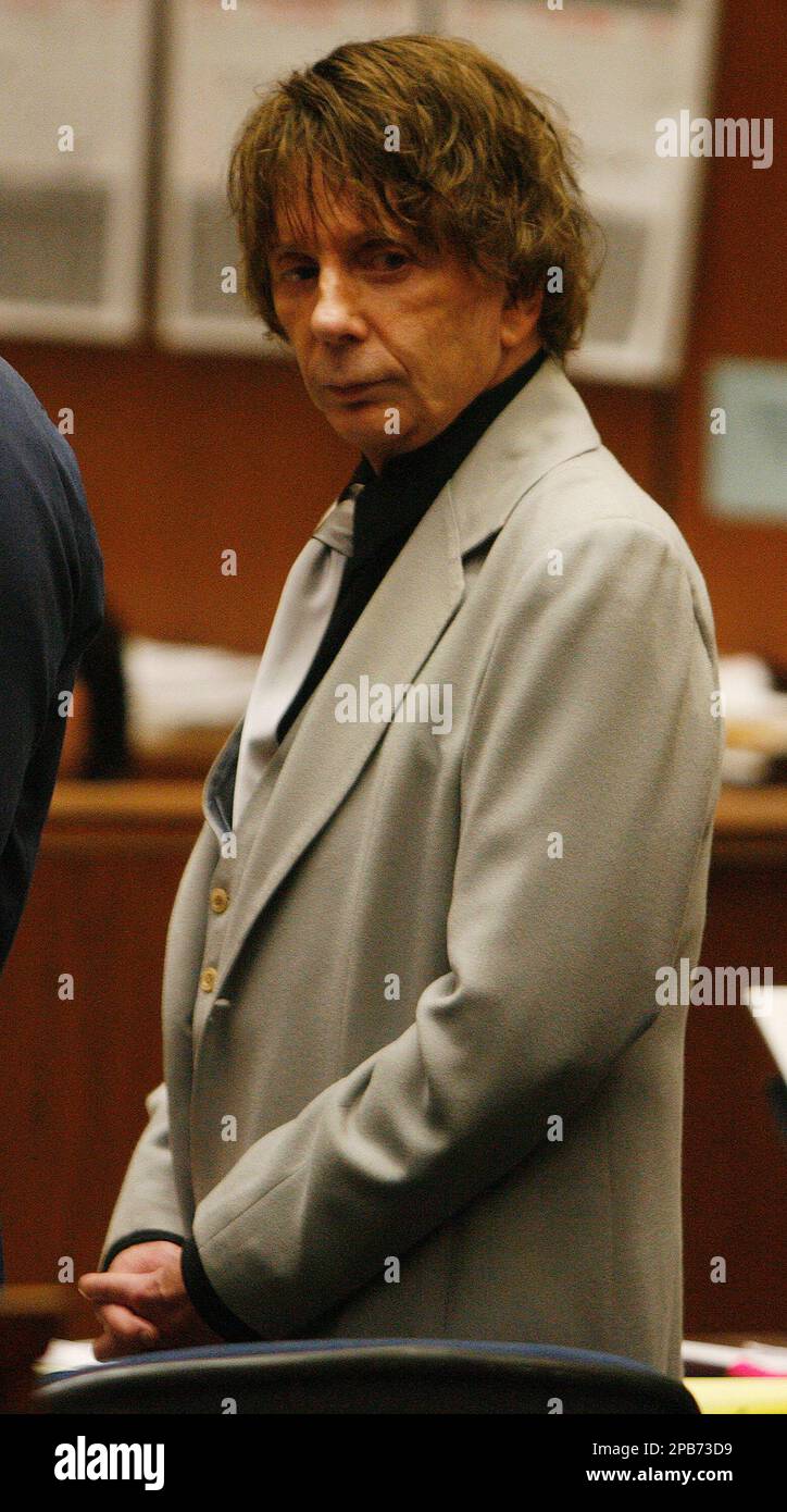 Music producer Phil Spector, stands as the jury enters the courtroom ...