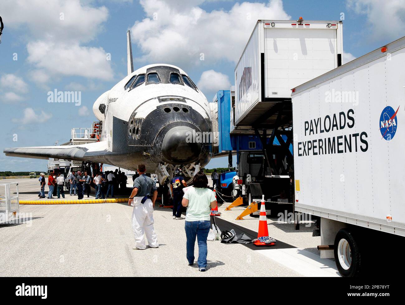 NASA workers secure the space shuttle Endeavour landing at the Kennedy ...