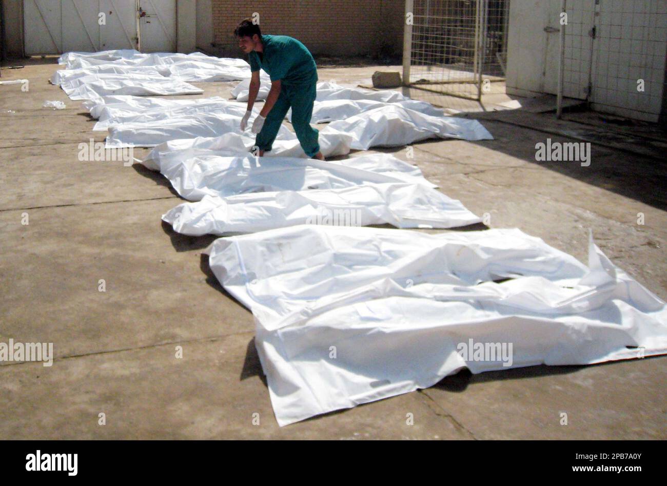 A morgue worker prepares for burial unidentified and unclaimed bodies ...