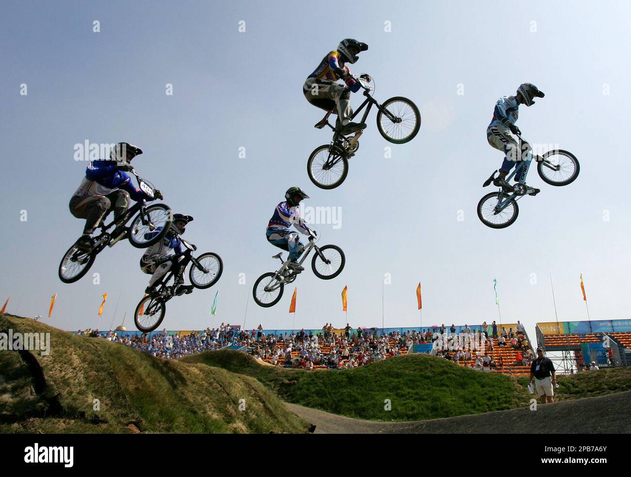 Riders clear a jump during a semi-final at the UCI Bicycle Motocross ...